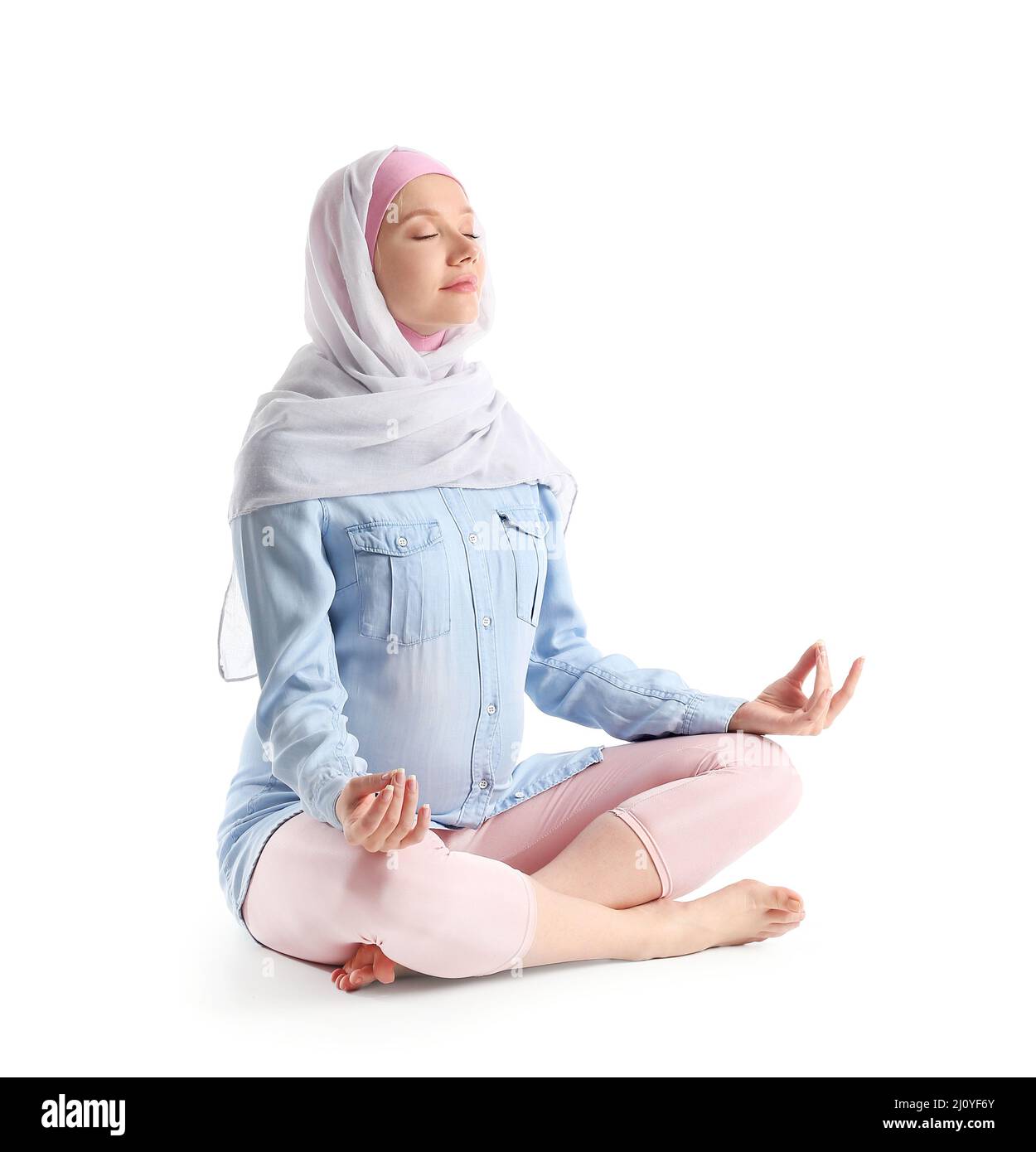 Pregnant Muslim woman meditating on white background Stock Photo - Alamy