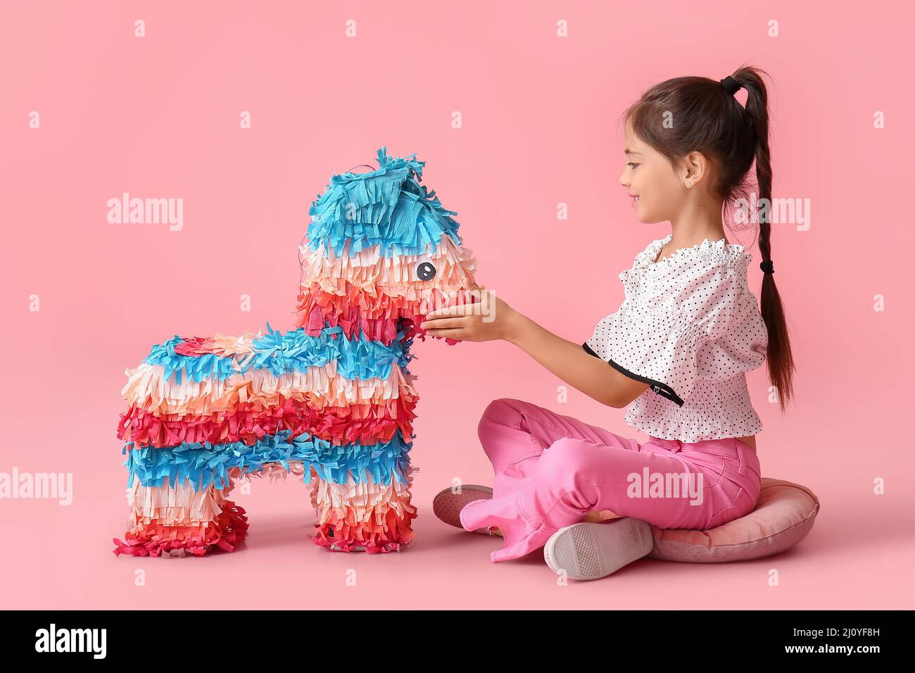 Little girl with Mexican pinata on color background Stock Photo - Alamy