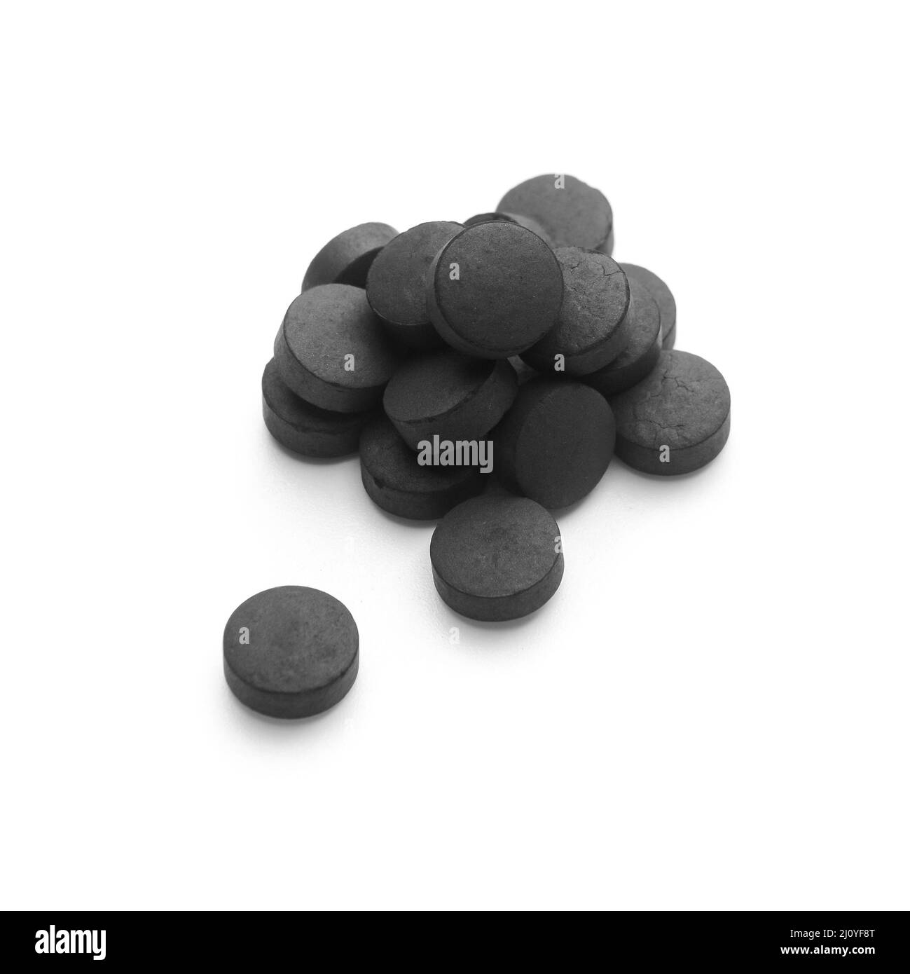 Heap of activated carbon pills on white background Stock Photo - Alamy