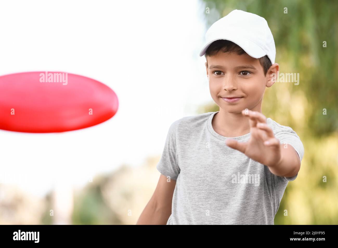 Cute little boy playing frisbee outdoors Stock Photo - Alamy