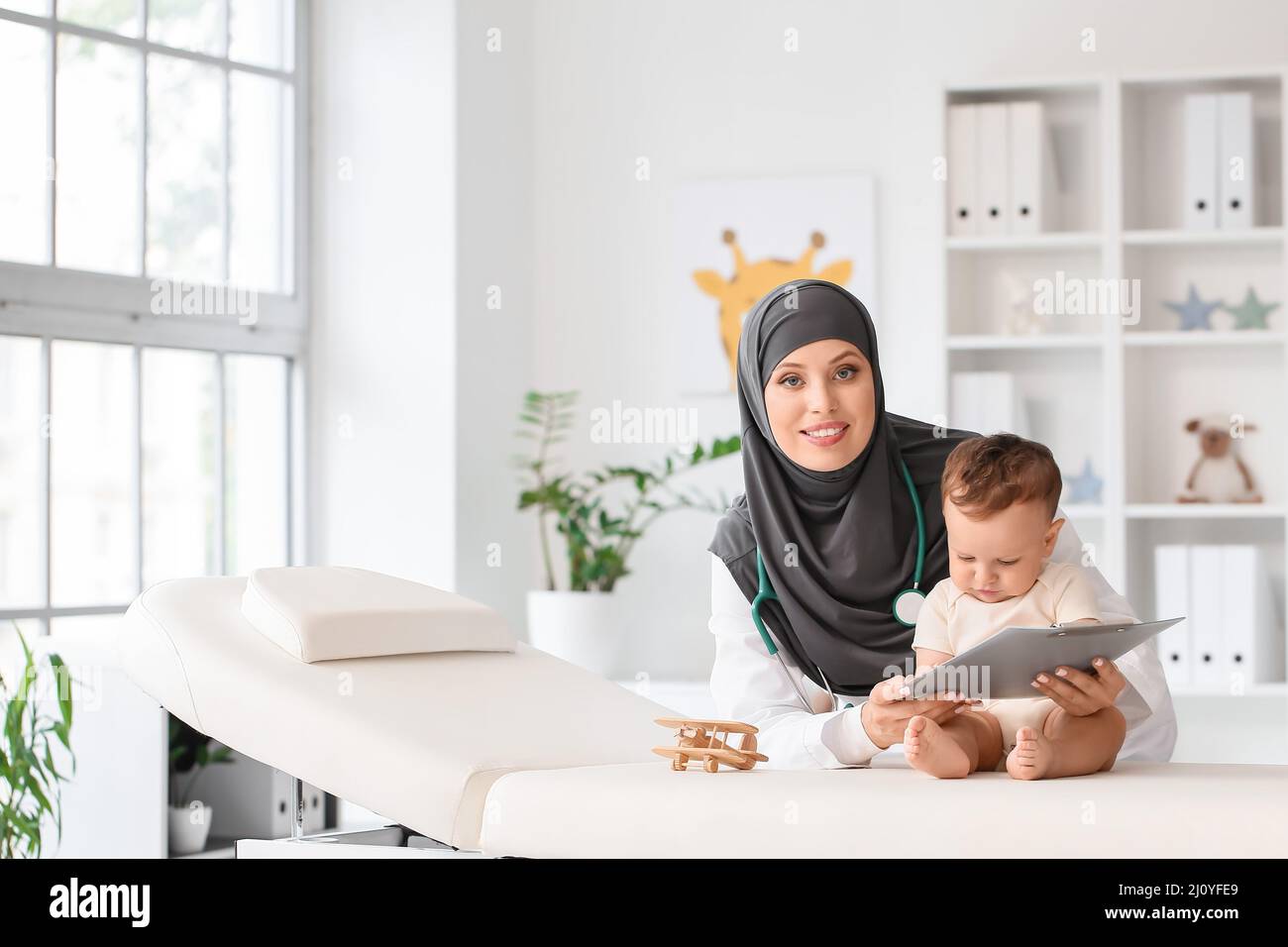 Muslim pediatrician examining baby boy in clinic Stock Photo - Alamy