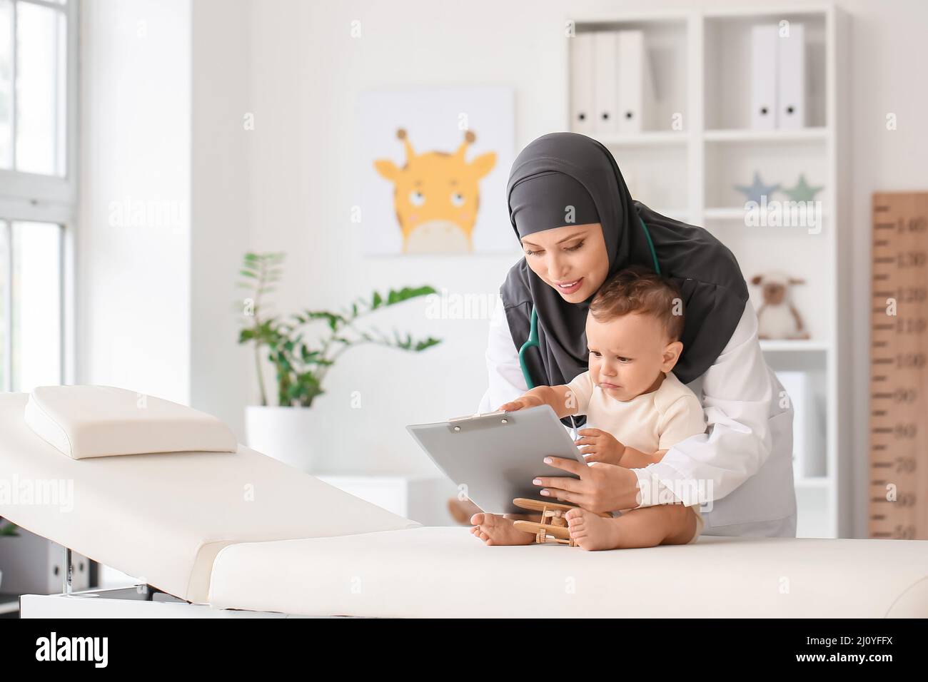 Muslim pediatrician examining baby boy in clinic Stock Photo - Alamy