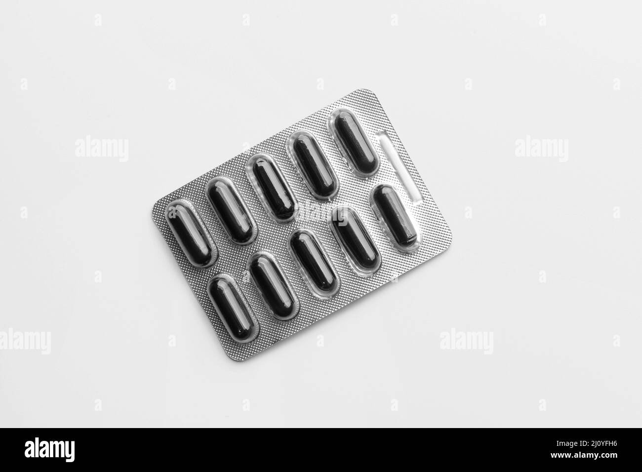 Blister package of activated carbon capsules on grey background Stock ...