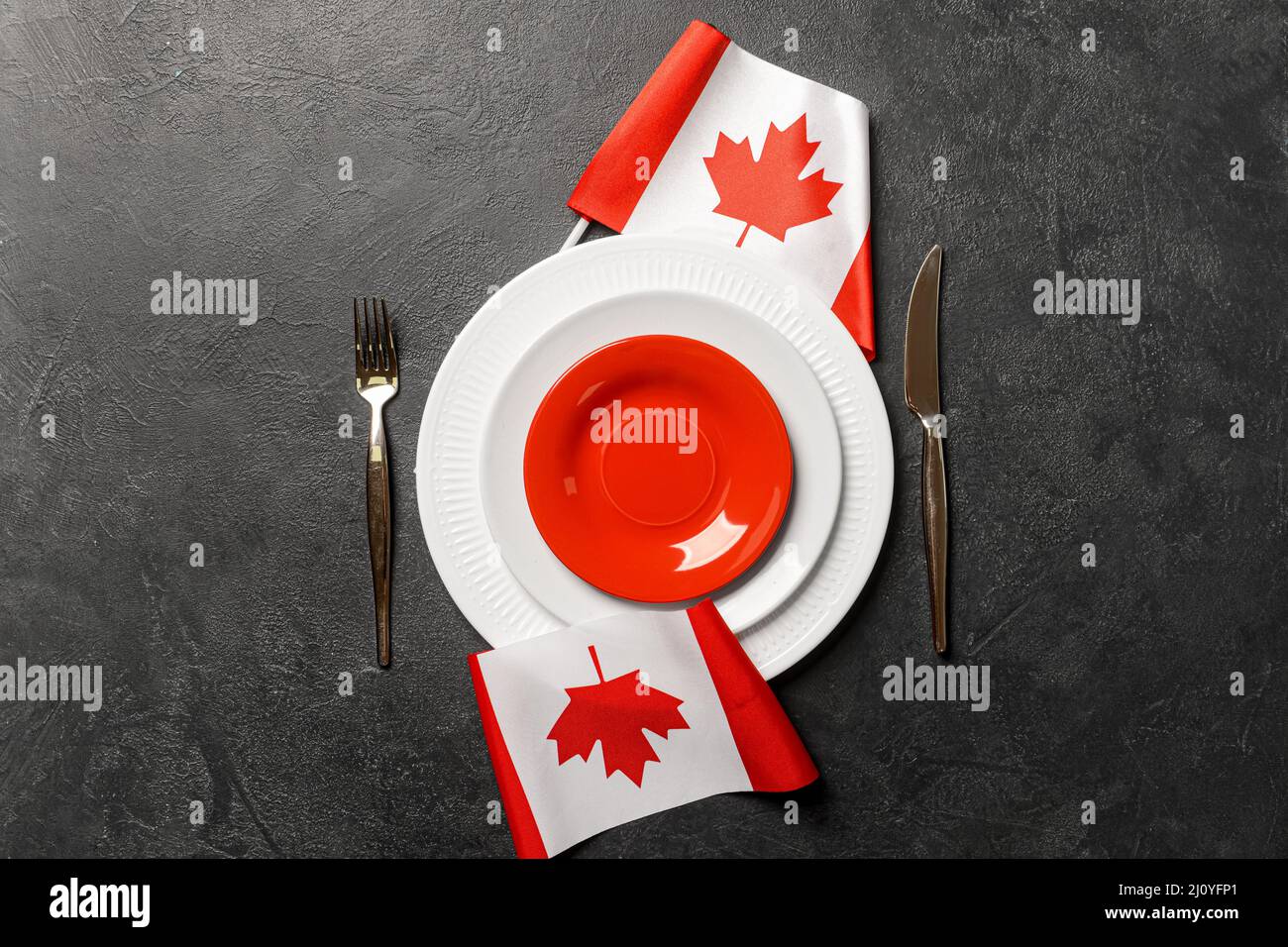 Table setting with Canadian flags on dark background Stock Photo - Alamy