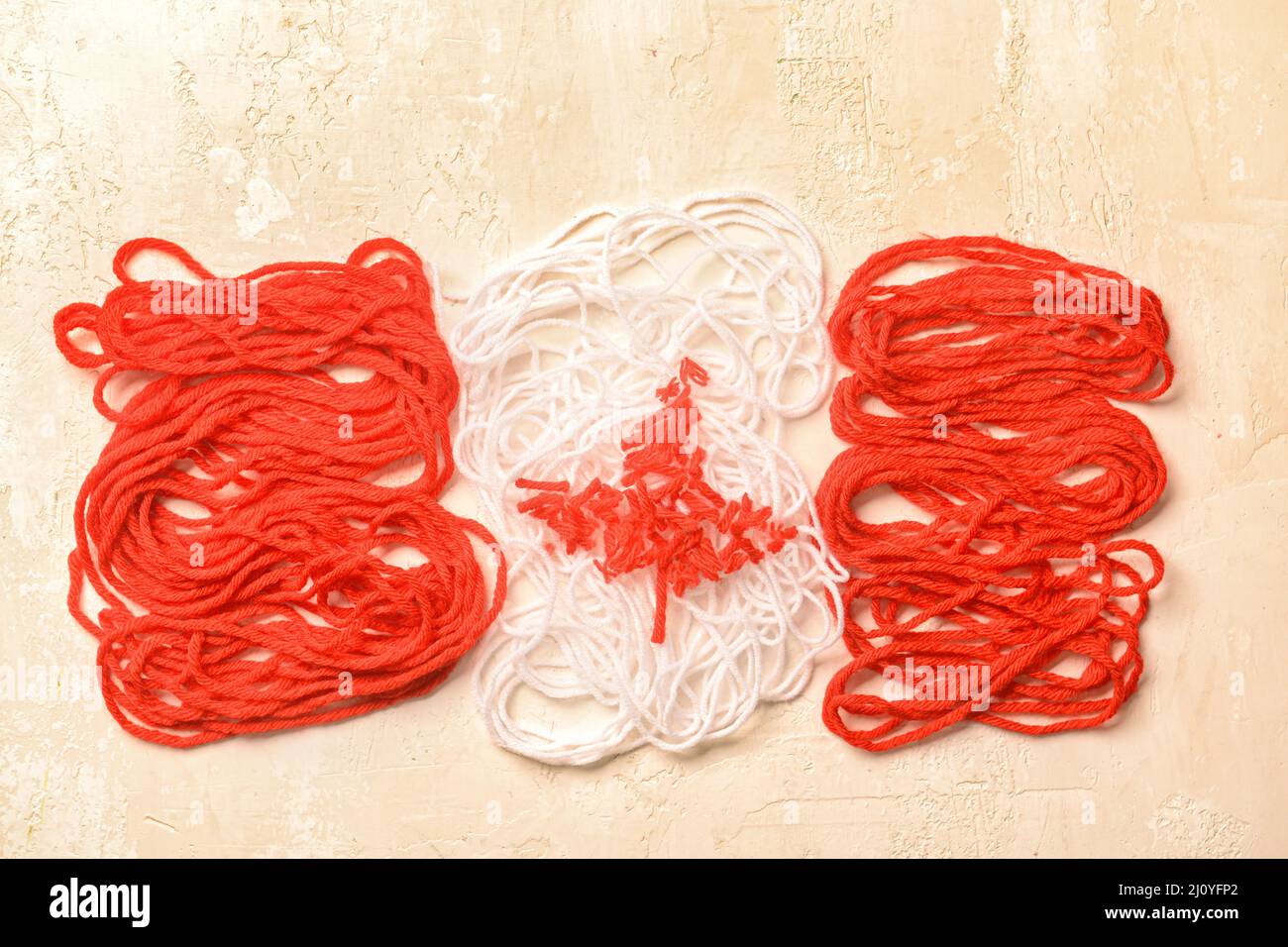 Canadian flag made of threads on light background Stock Photo - Alamy