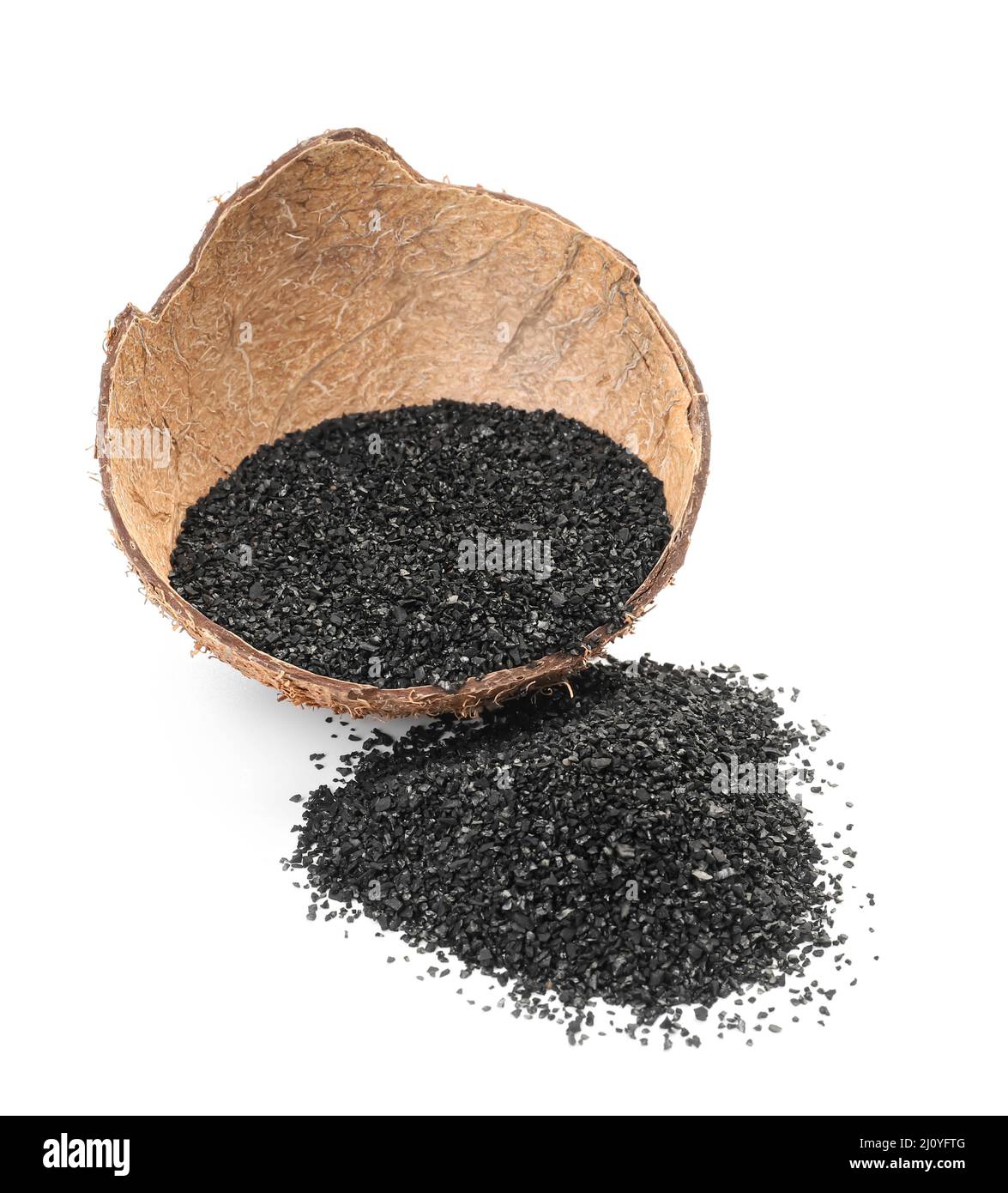 Coconut shell with activated carbon on white background Stock Photo - Alamy