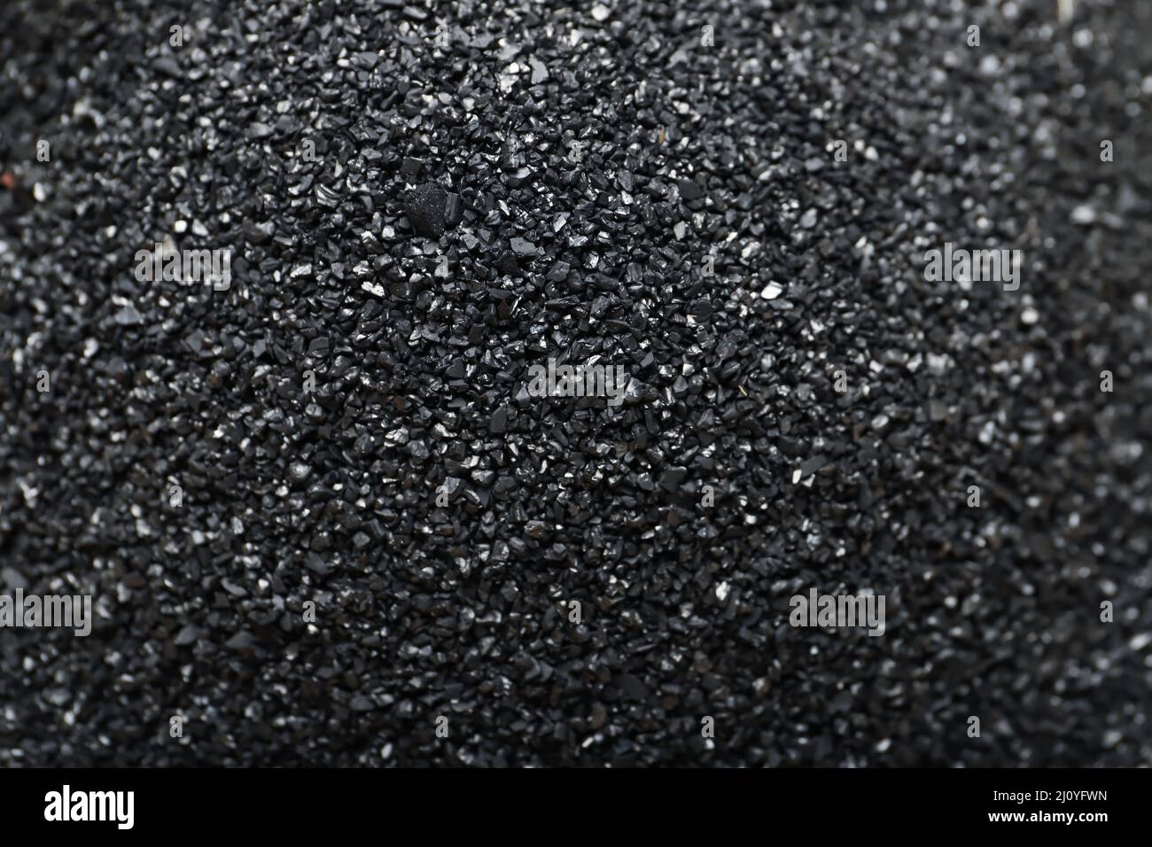 Coconut activated carbon as background Stock Photo - Alamy