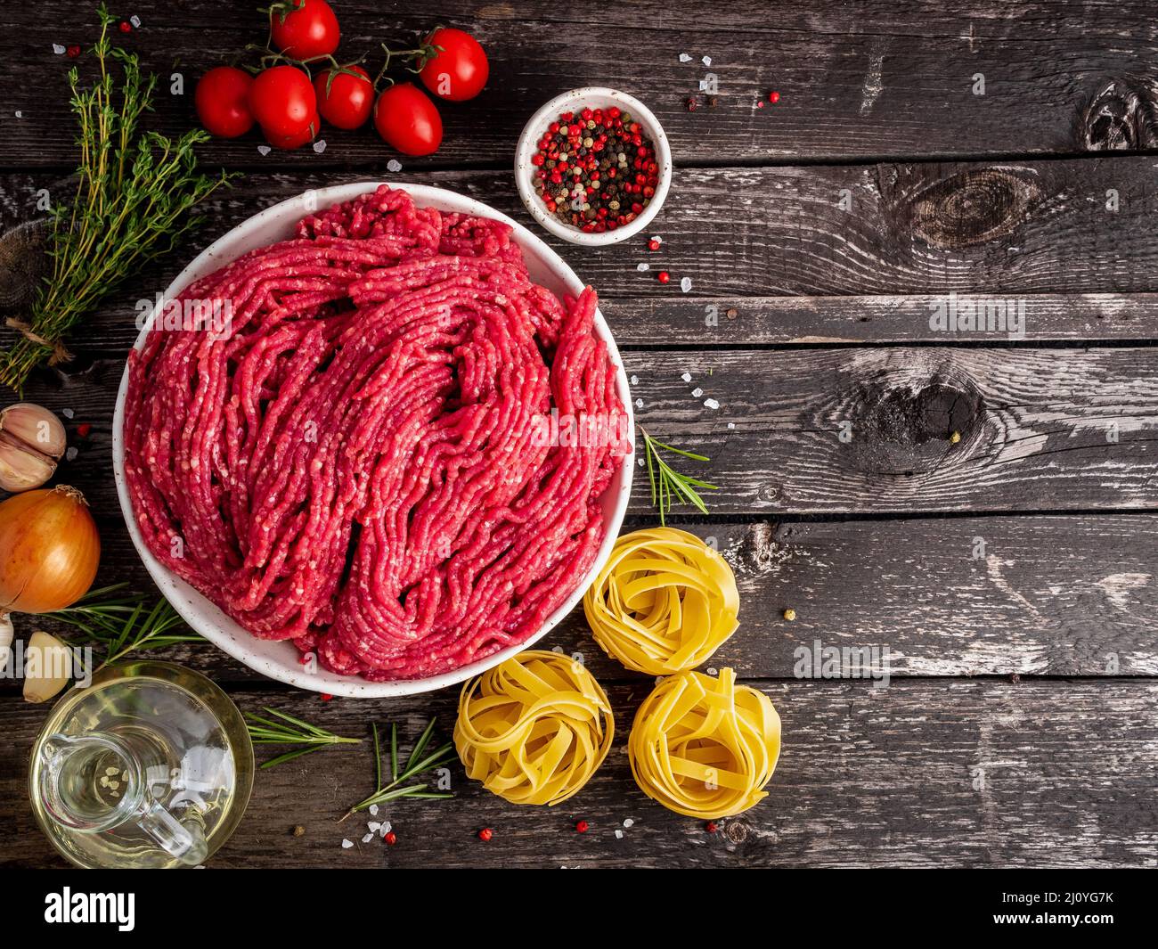 Mince beef, ground meat with ingredients for cooking on dark blue Stock ...