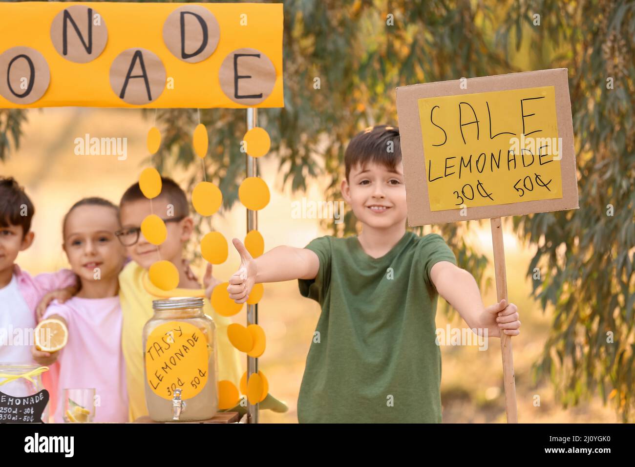 Cute children selling lemonade in park Stock Photo - Alamy