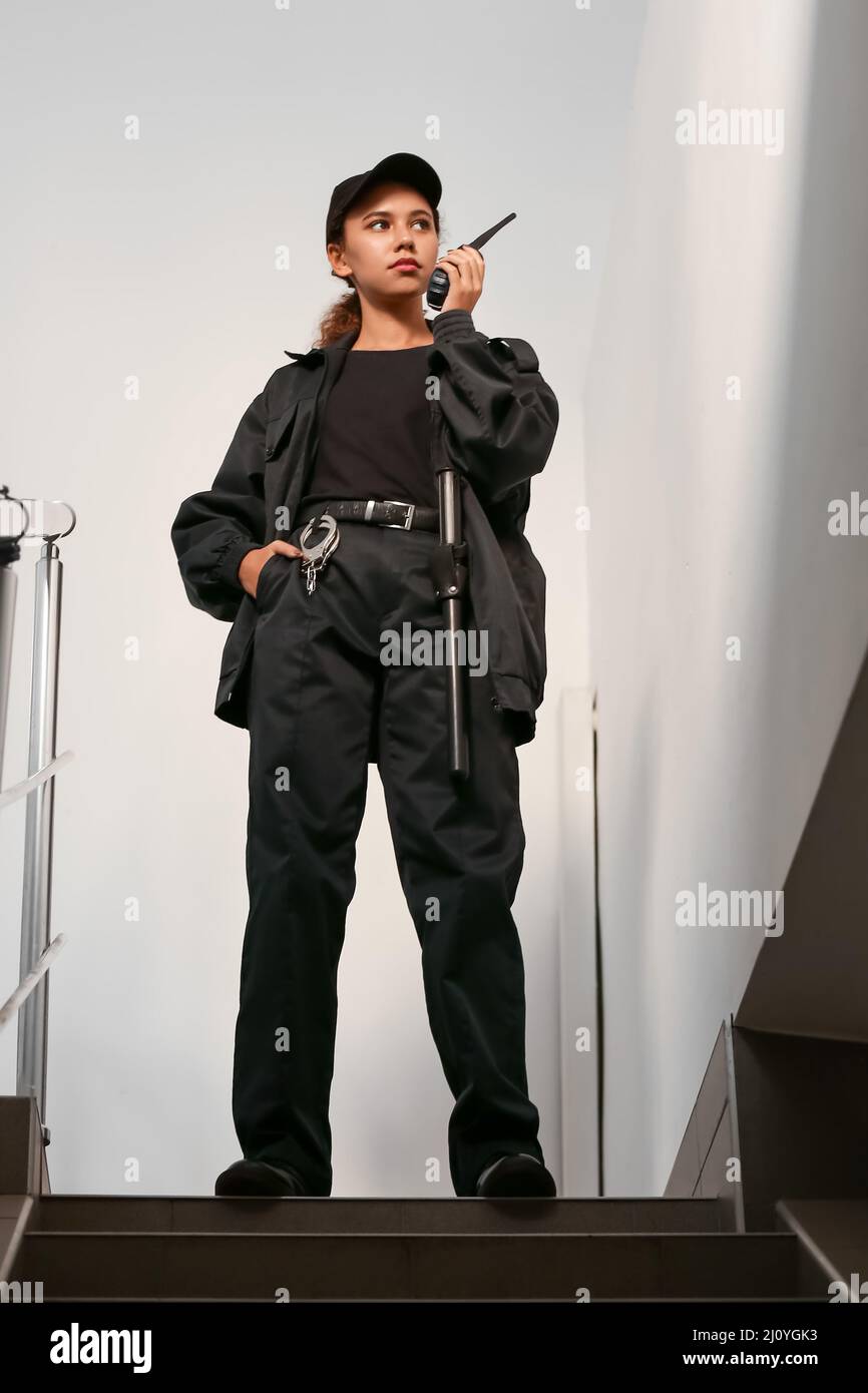 African-American female security guard with radio transmitter in ...