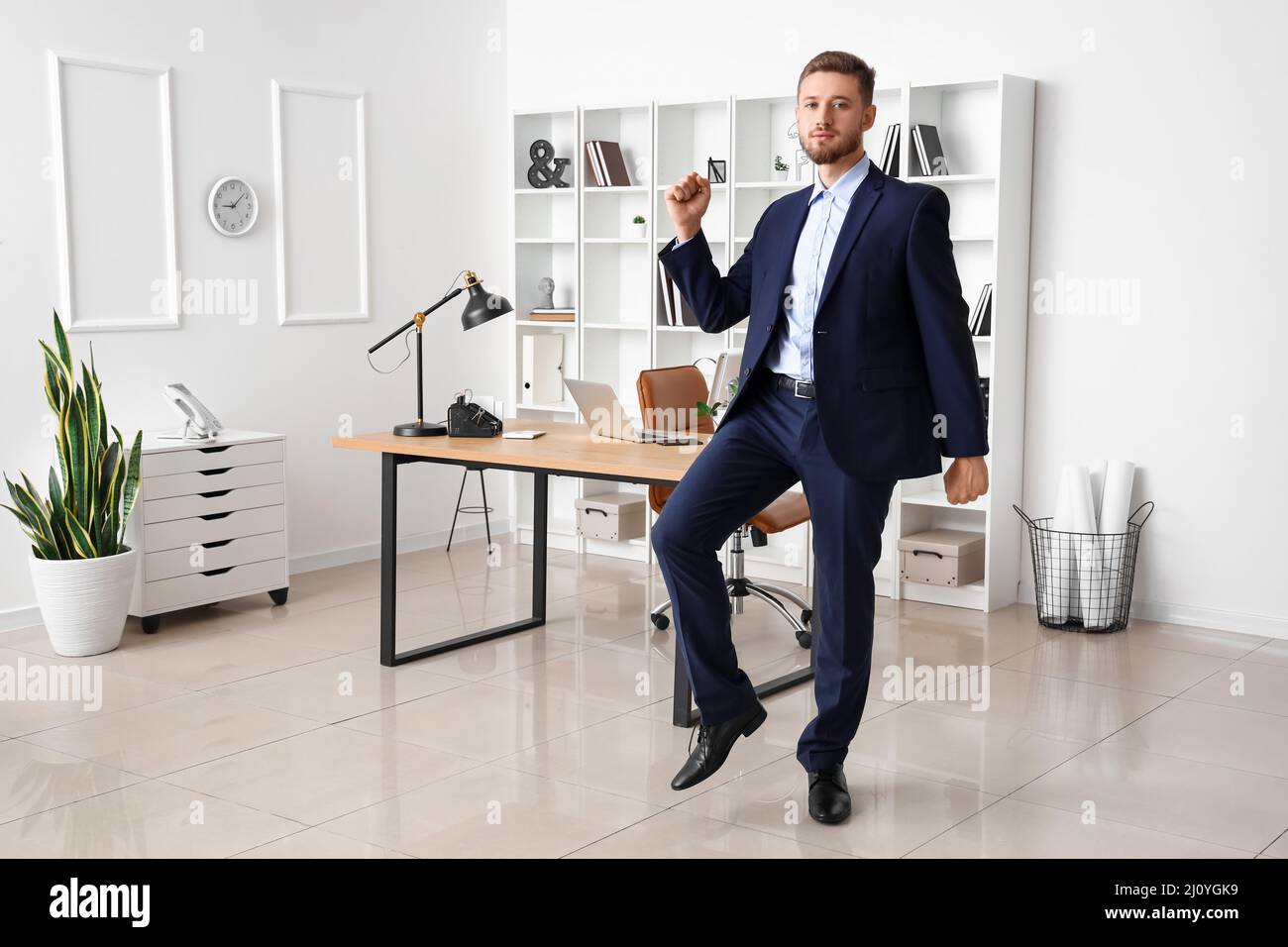 Handsome young businessman dancing in office Stock Photo - Alamy
