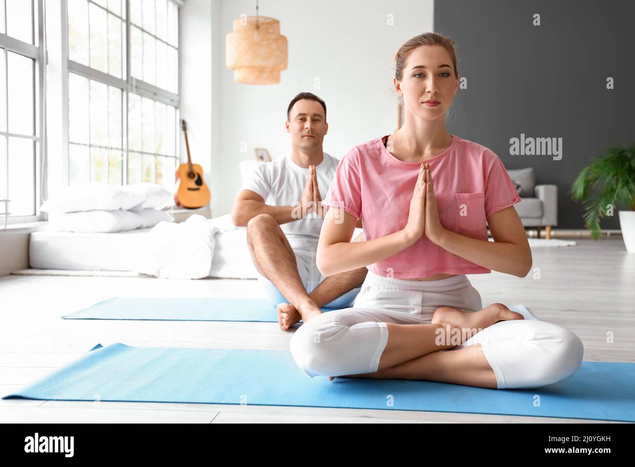Couple meditating namaste hi-res stock photography and images - Alamy