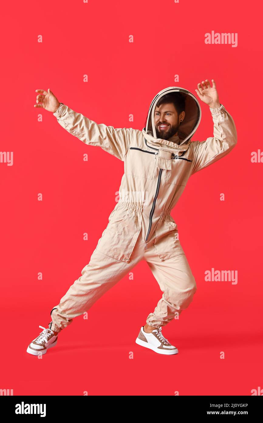 Dancing beekeeper on red background Stock Photo - Alamy