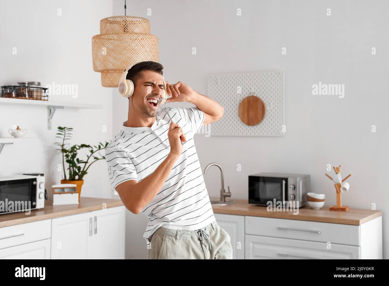 Man dancing in kitchen listening hi-res stock photography and images ...