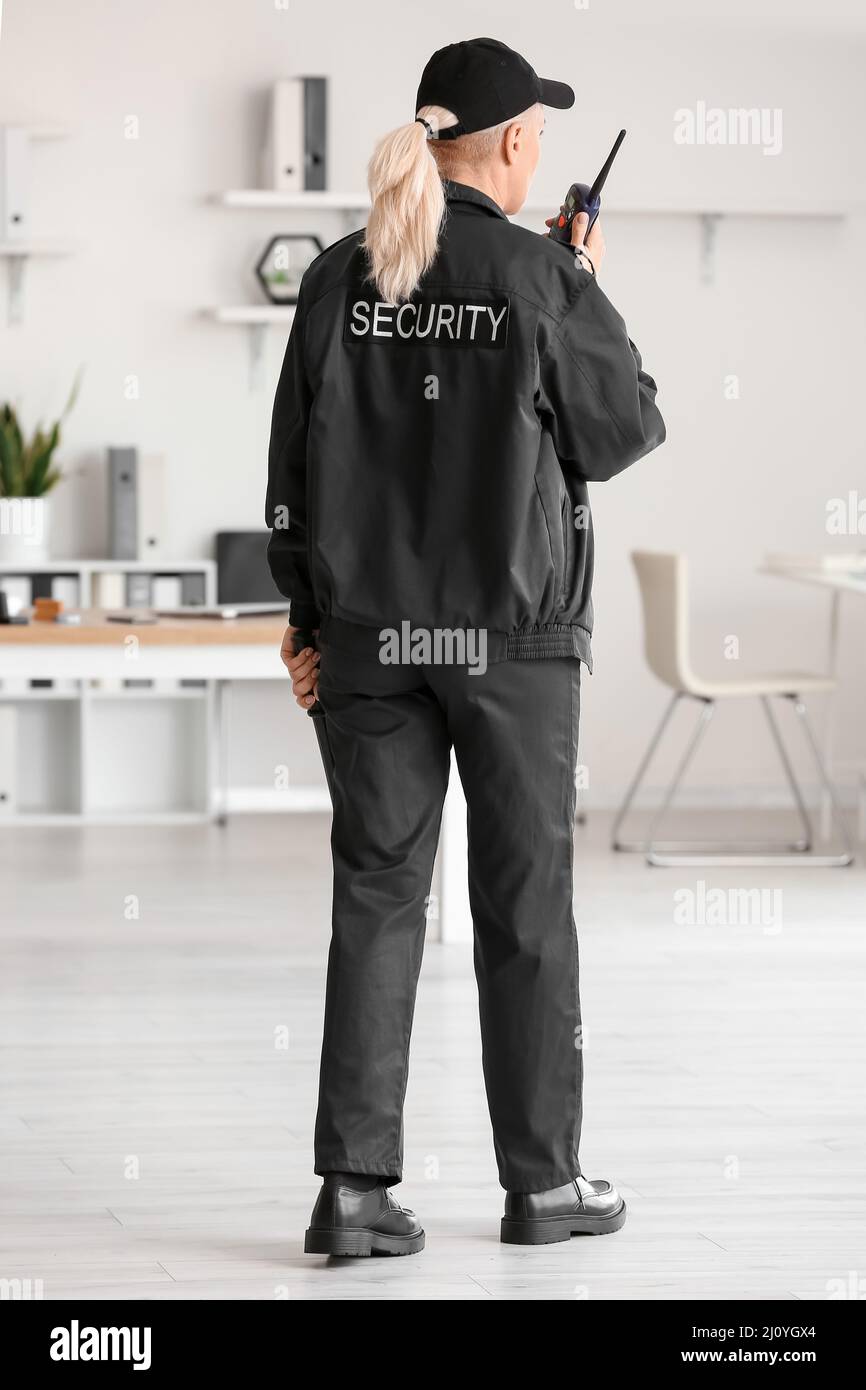 Female security guard with radio transmitter in office Stock Photo - Alamy