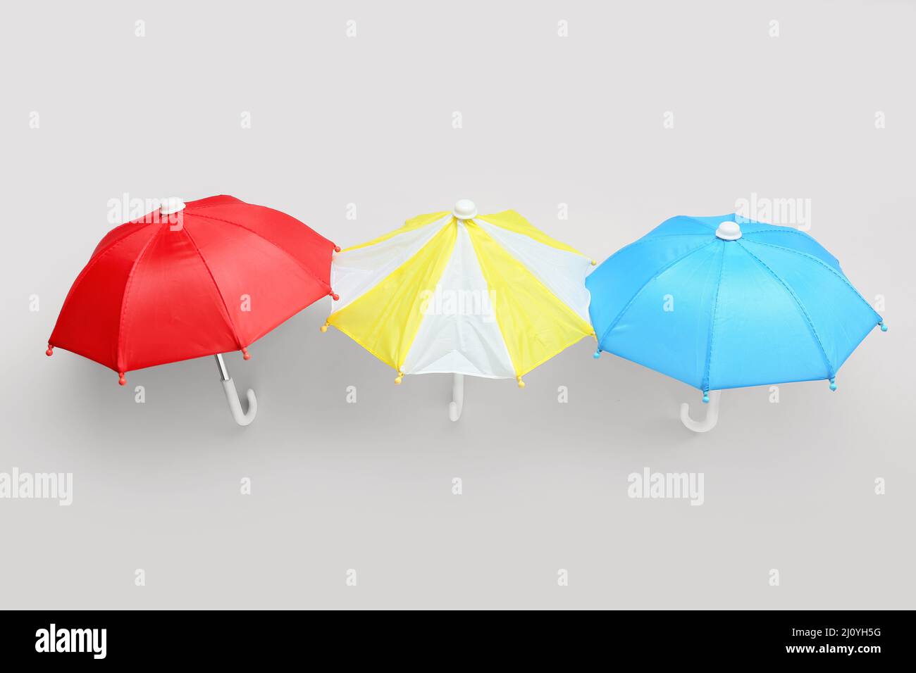 Different umbrellas on white background Stock Photo - Alamy