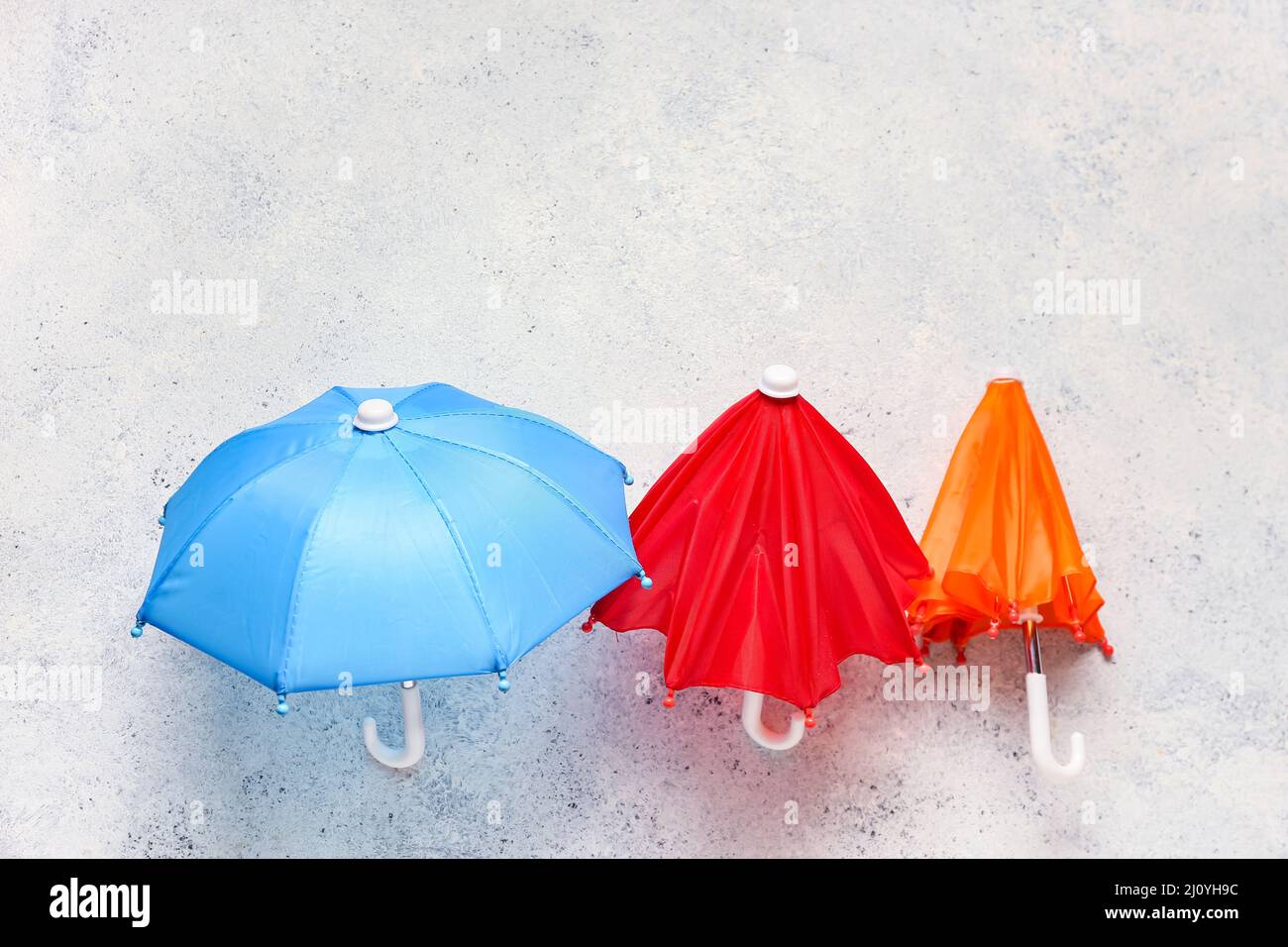 Different umbrellas on light background Stock Photo - Alamy