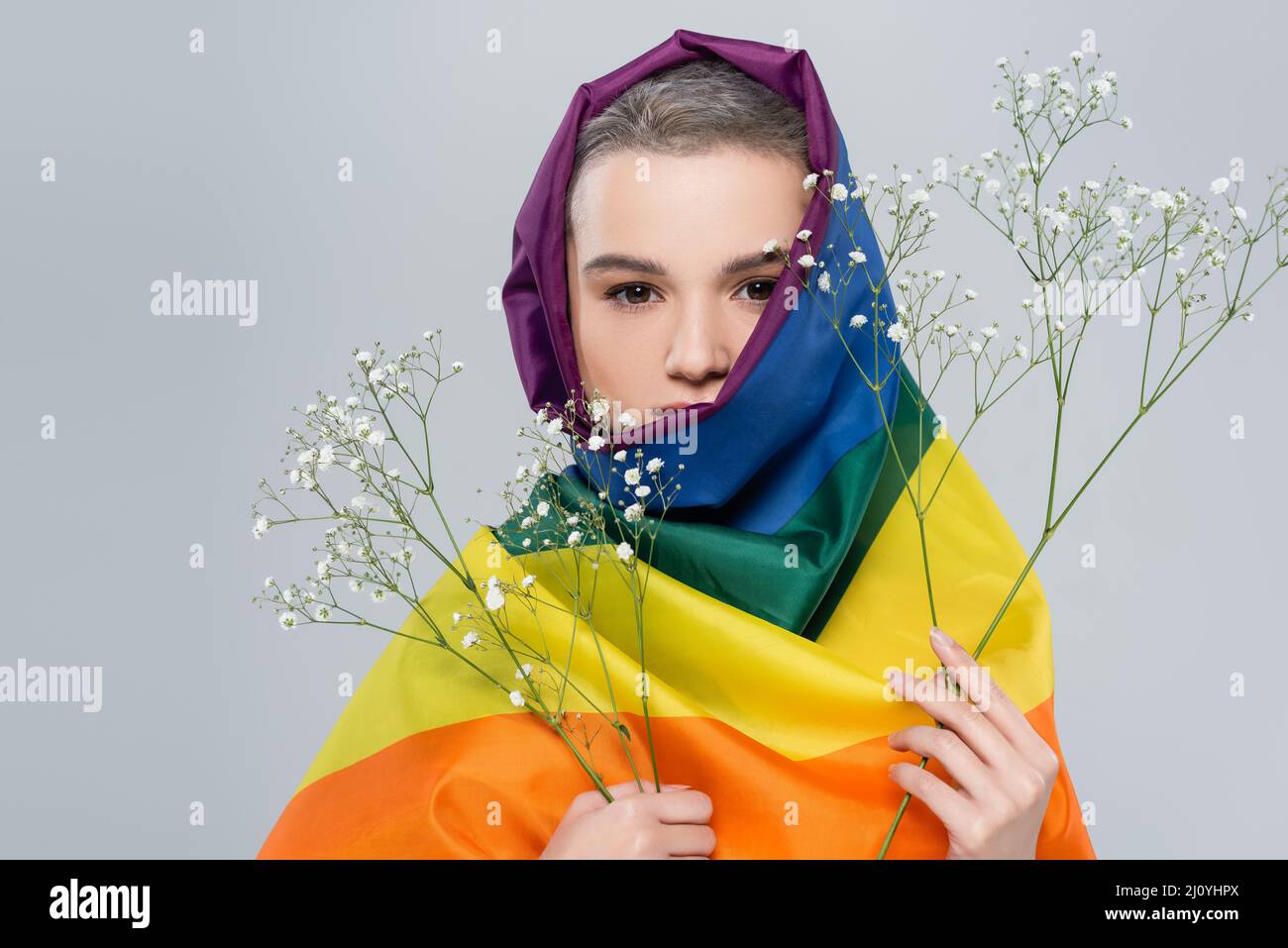 woman with lgbt flag on head holding gypsophila flowers isolated on ...