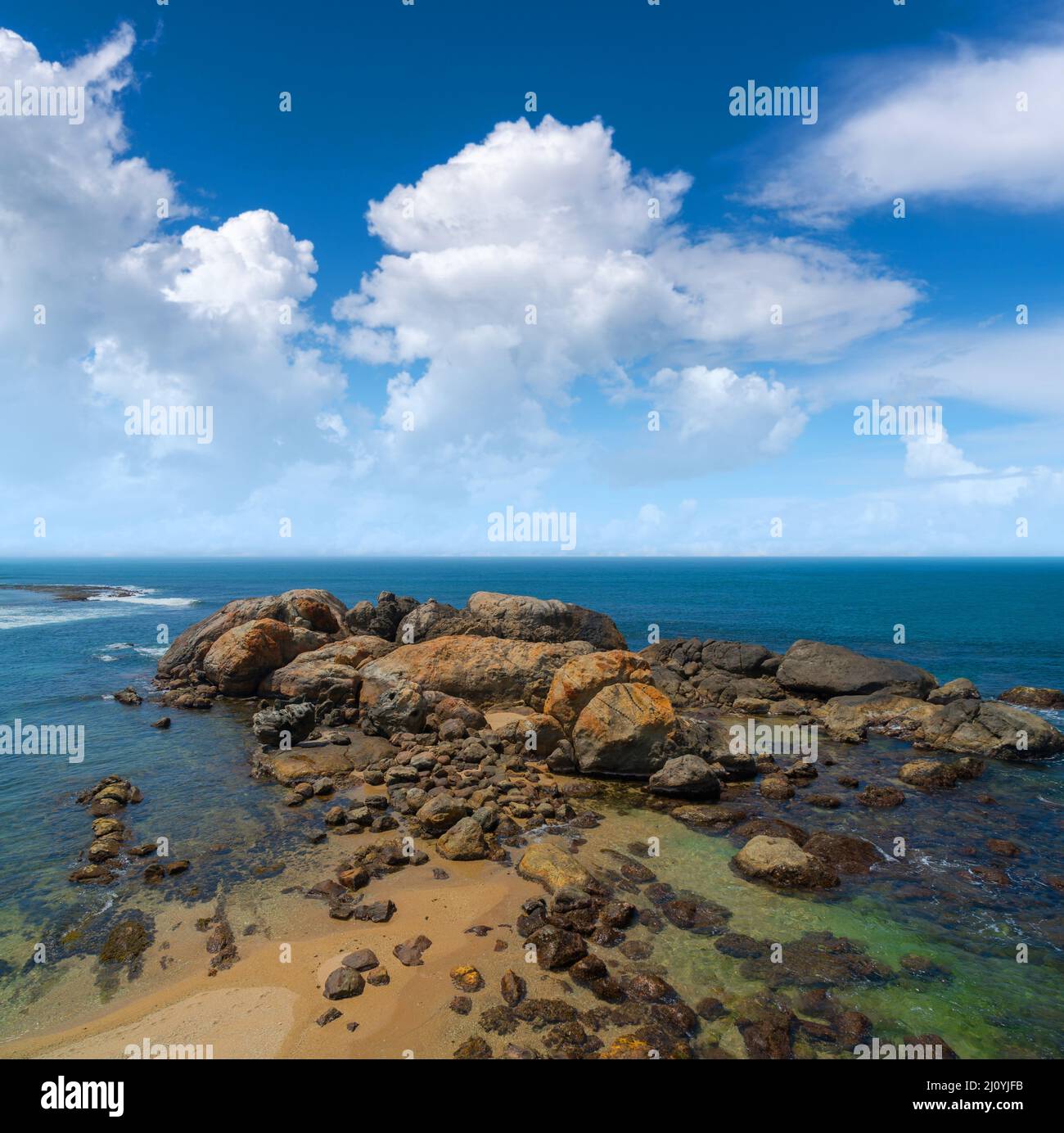 Sunny beach large rocks hi-res stock photography and images - Alamy