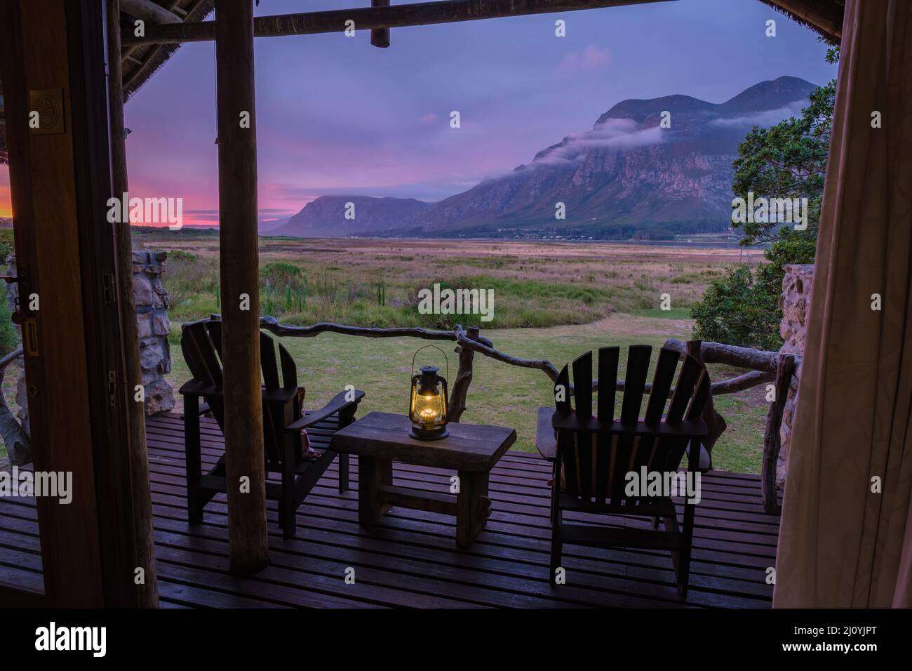 Cabin lodge during sunset Mountains and grassland near Hermanus at the ...