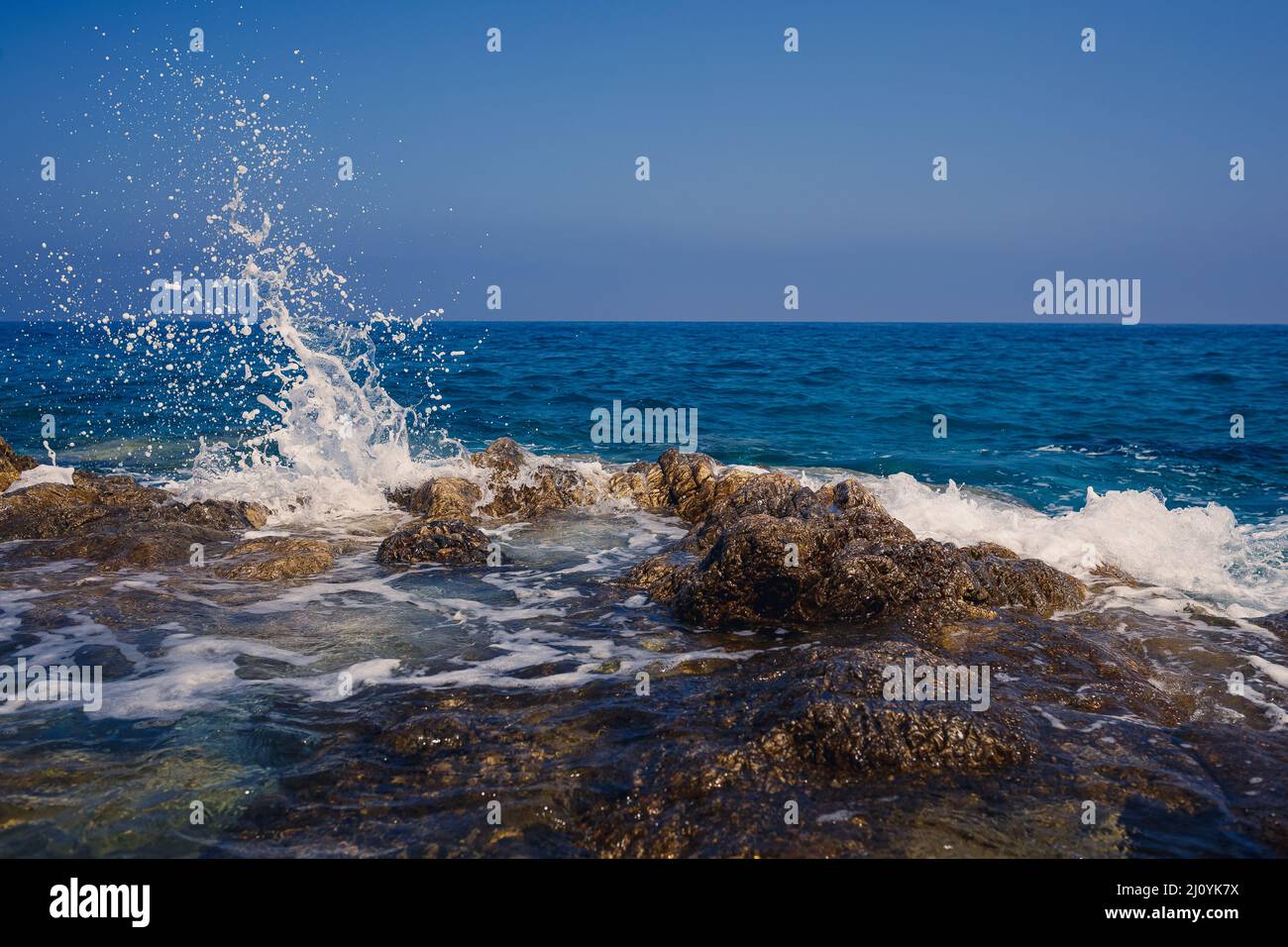 Wonderful views of the blue Mediterranean Sea. Sunny rocks, waves with ...