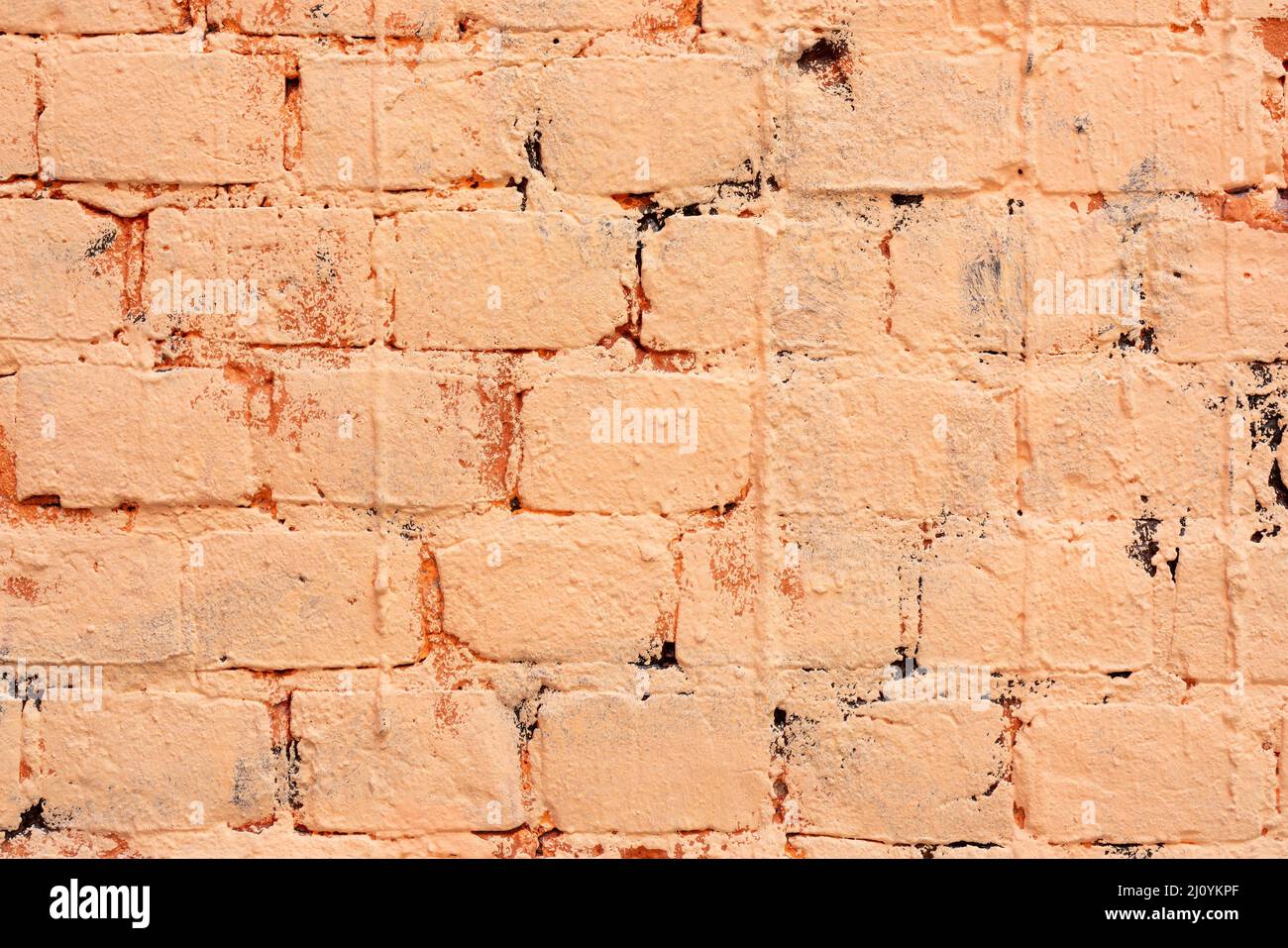 Brick wall is painted with orange paint. Abstract architectural ...