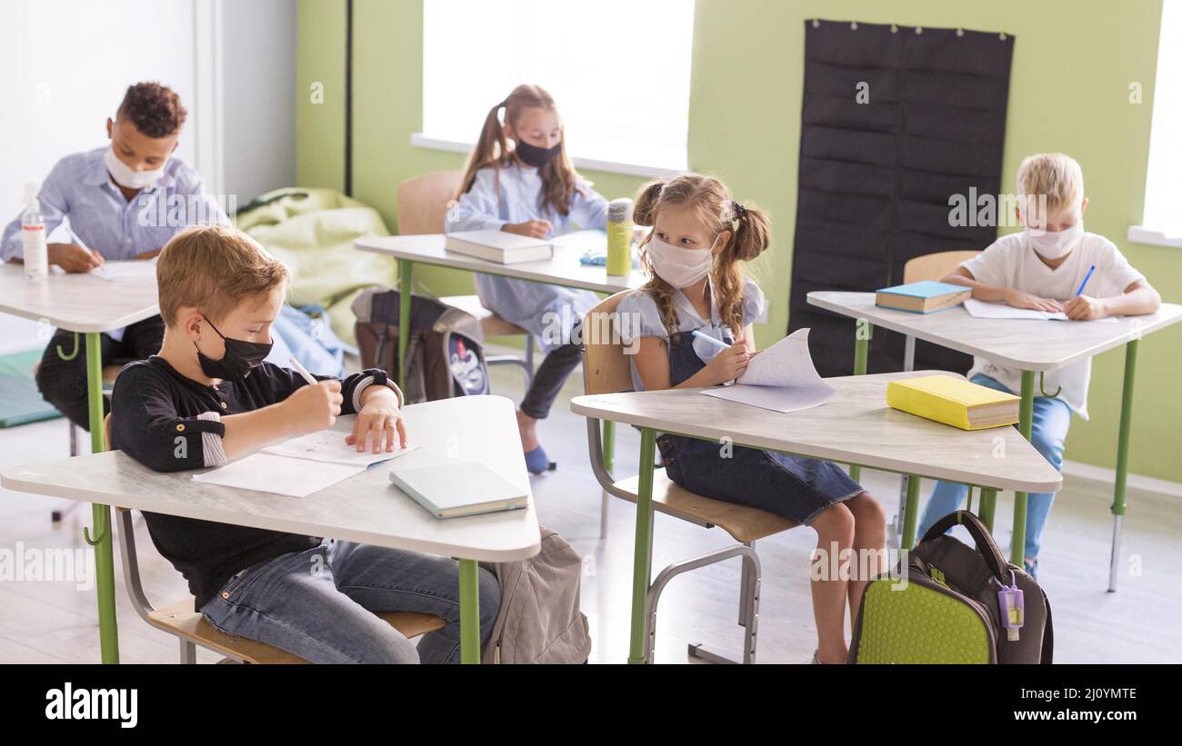 Kids protecting themselves with face masks class. High quality photo ...