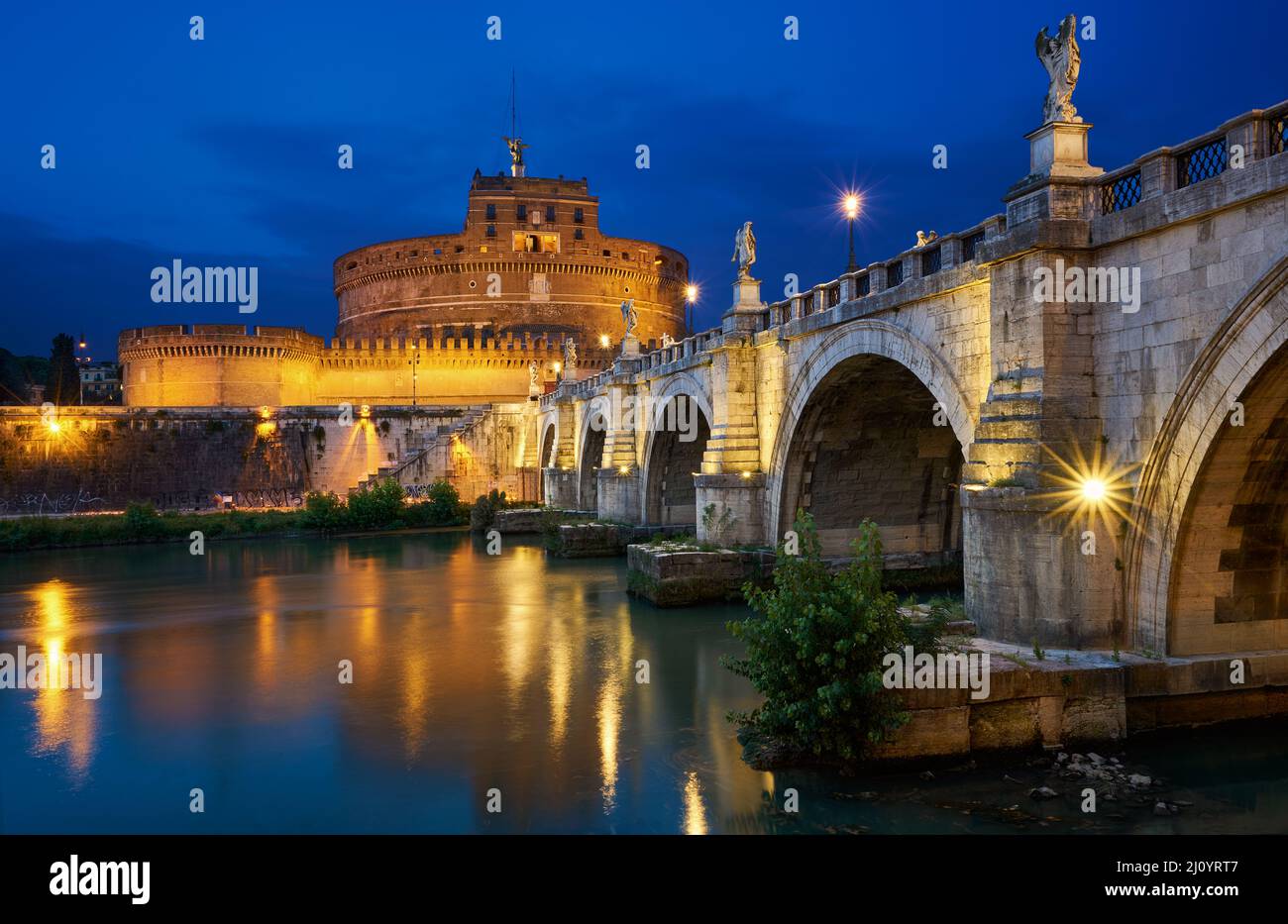 Ponte St Angelo Bridge and castle at night in Rome, Italy Stock Photo ...