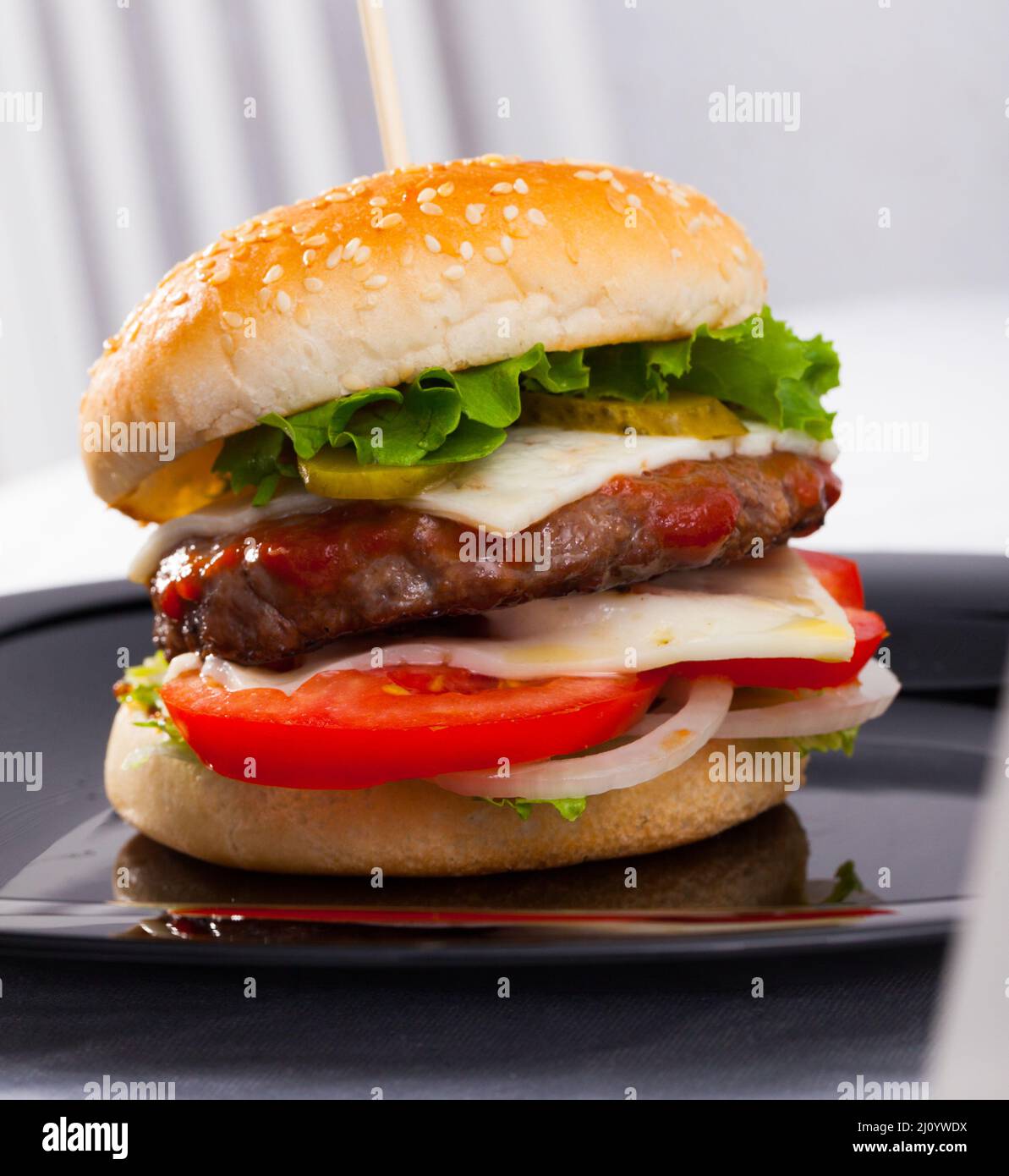 Delicious tasty burger with beef cutlet, fresh vegetables and cheese ...