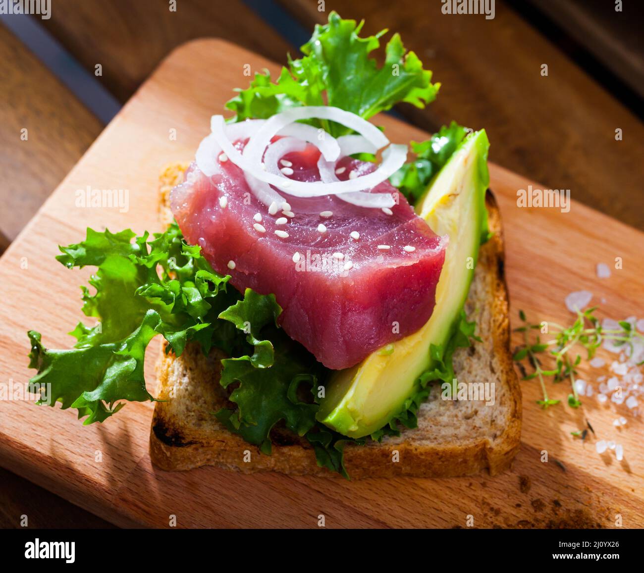 Toast with raw tuna and avocado Stock Photo - Alamy