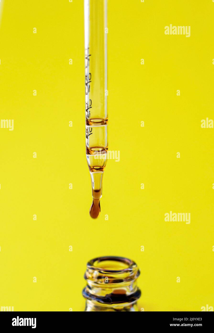 Photo of a pipette with liquid on a yellow background Stock Photo - Alamy