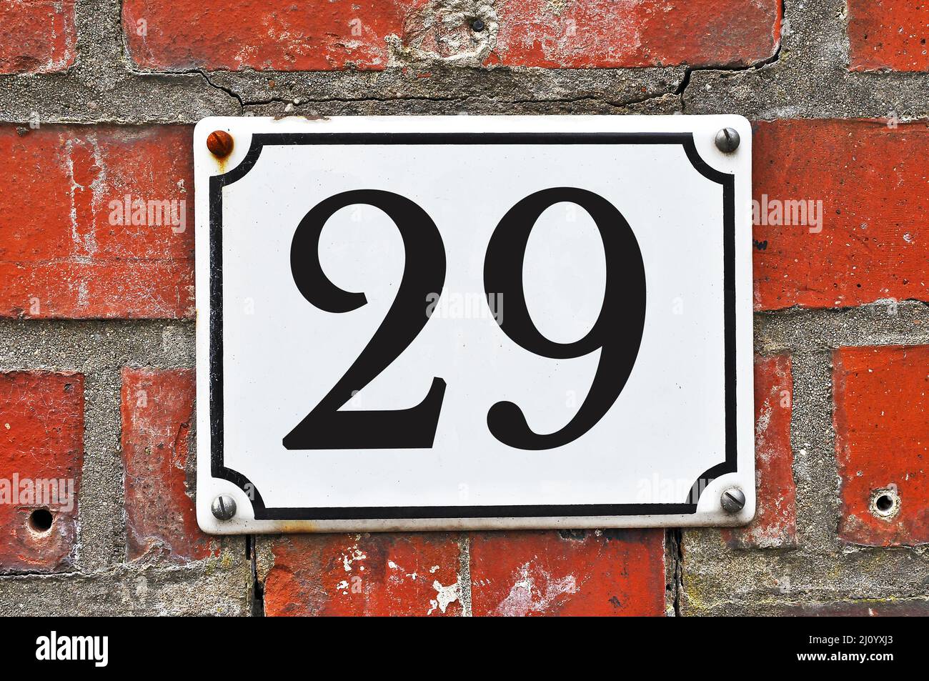 Sign of a street number 29 on a red brick wall Stock Photo - Alamy