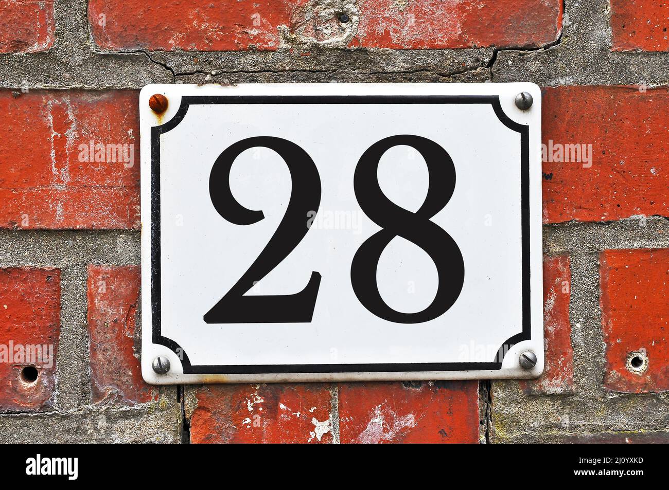 Sign of a street number 28 on a red brick wall Stock Photo - Alamy