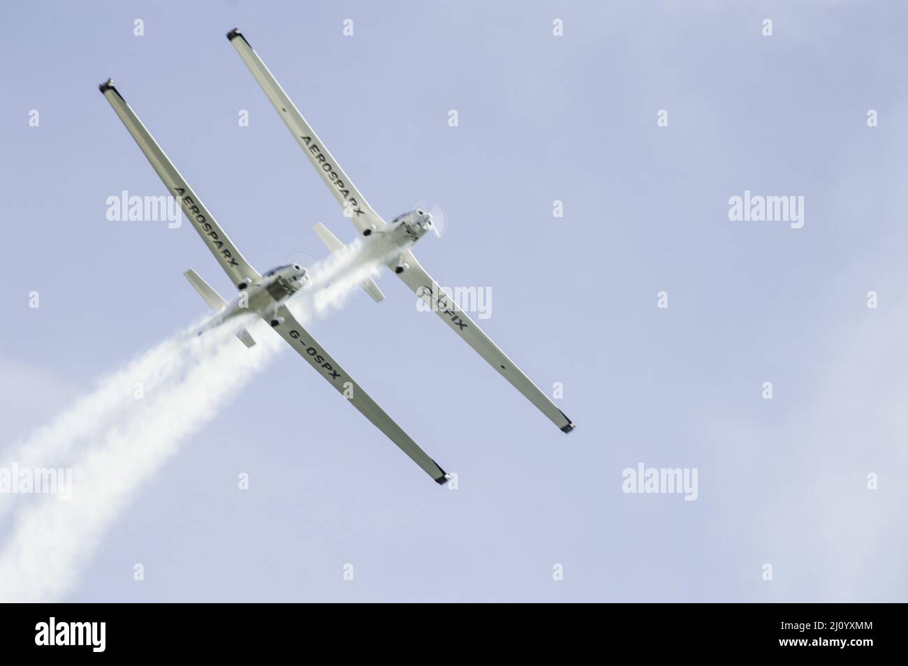 Twin plane acrobatics performance in the sky with smoke Stock Photo - Alamy