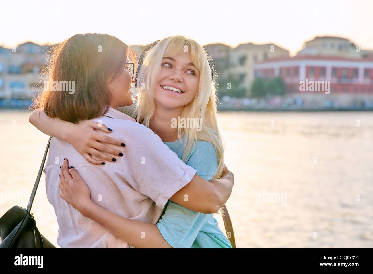 Happy mom and teenage daughter hugging together Stock Photo - Alamy