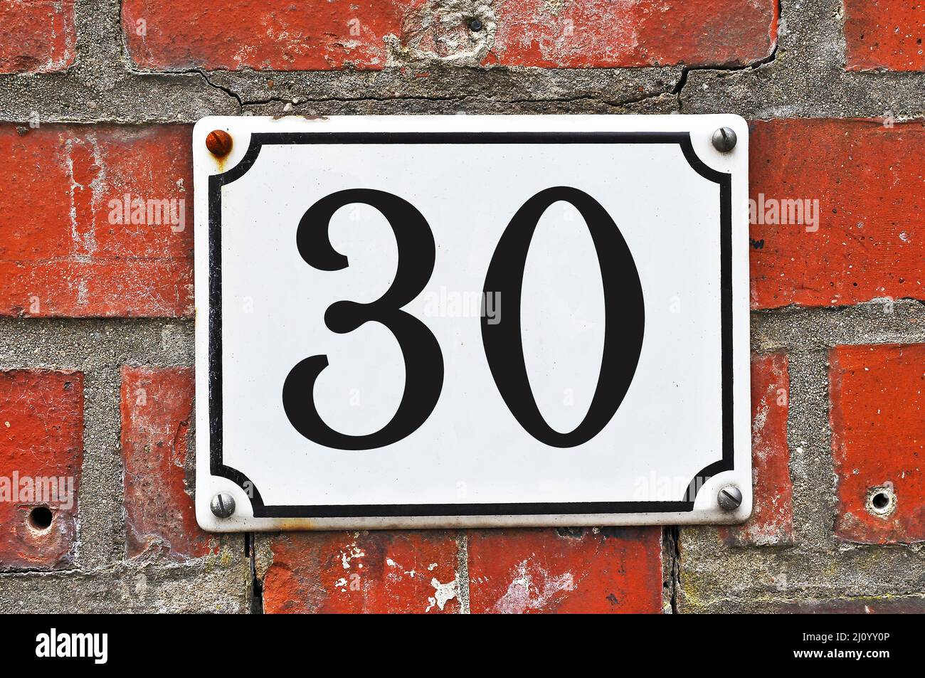 Sign of a street number 30 on a red brick wall Stock Photo - Alamy
