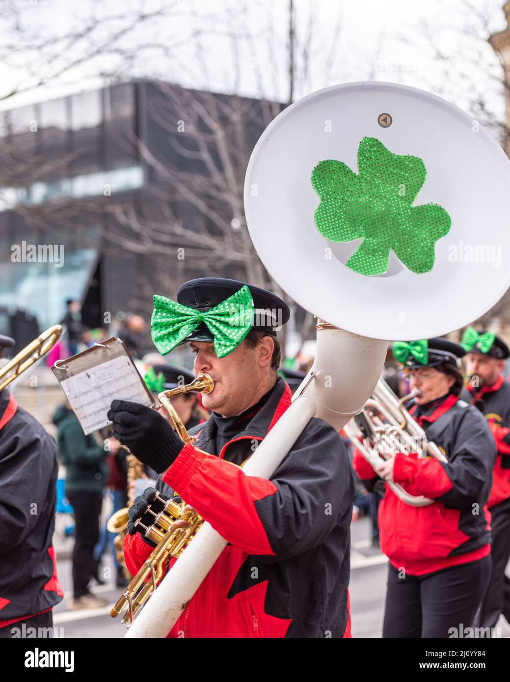 A man playing a trombone decorated with a shamrock during the Saint ...