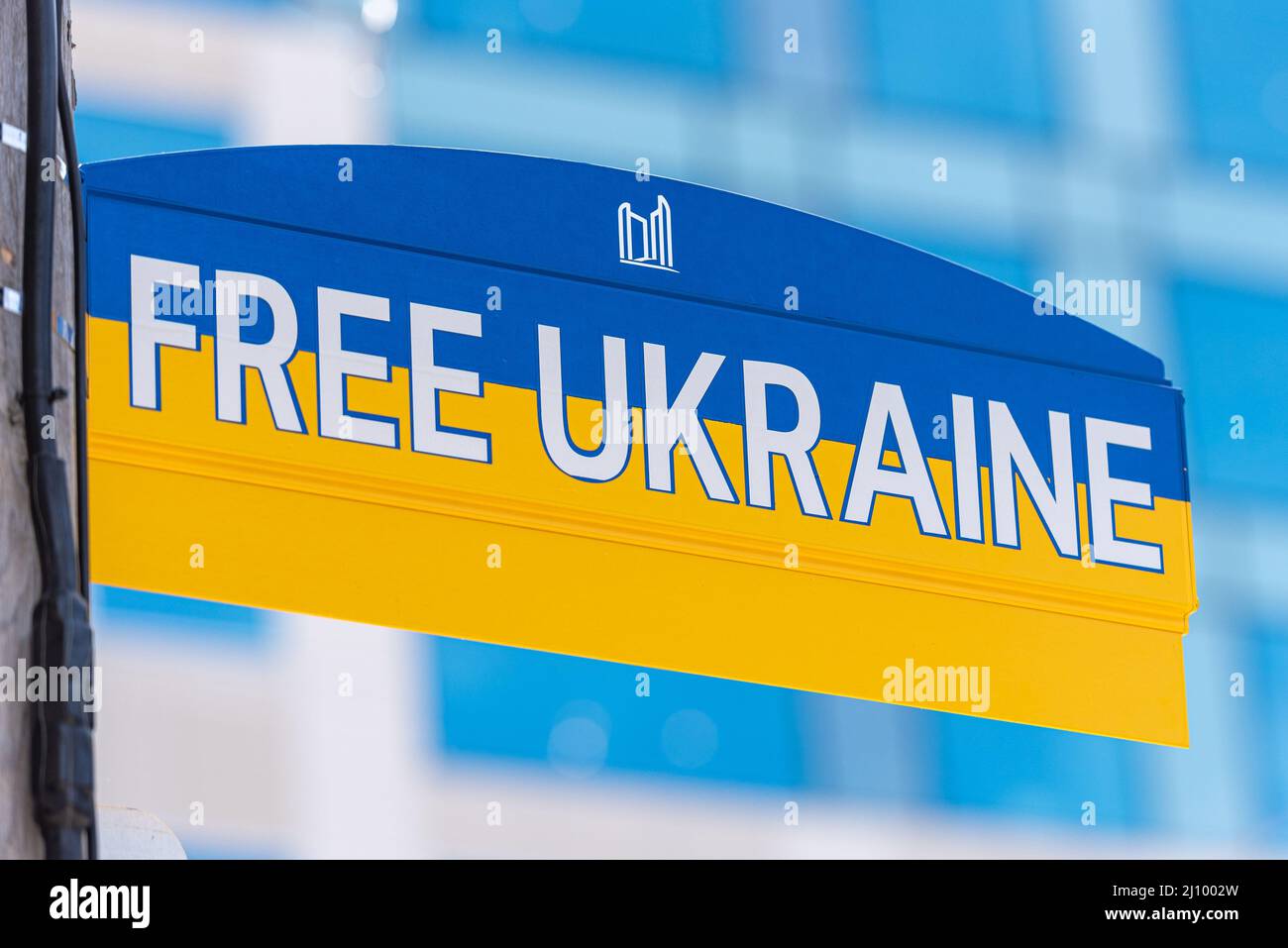 A symbolic street sign reading 'Free Ukraine' is installed in front of ...