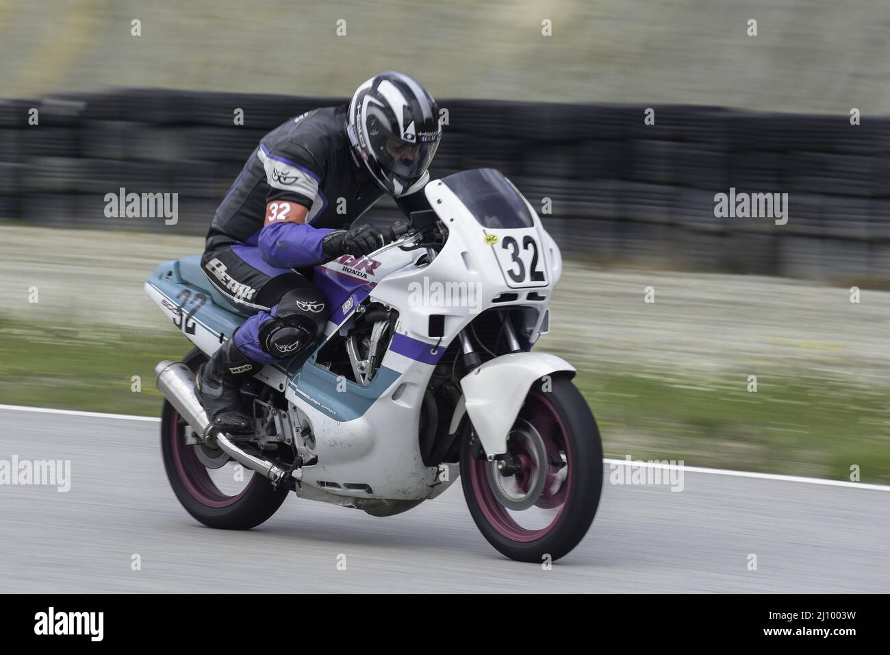 Classic racing sport motorbike running in the asphalt track Stock Photo ...
