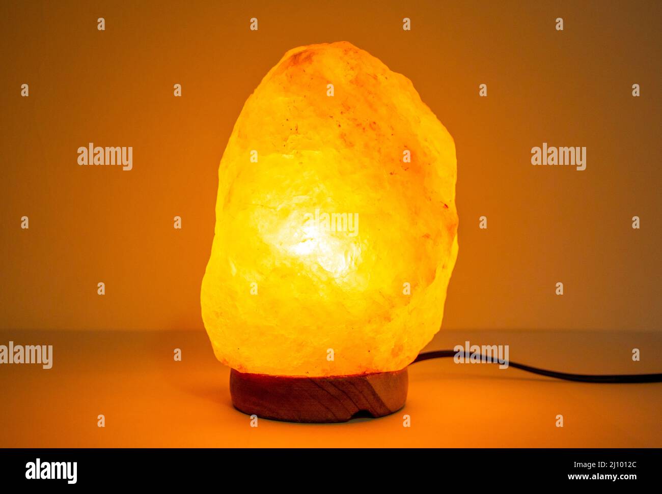 Orange salt lamp. Orange light himalayan lamp Stock Photo - Alamy