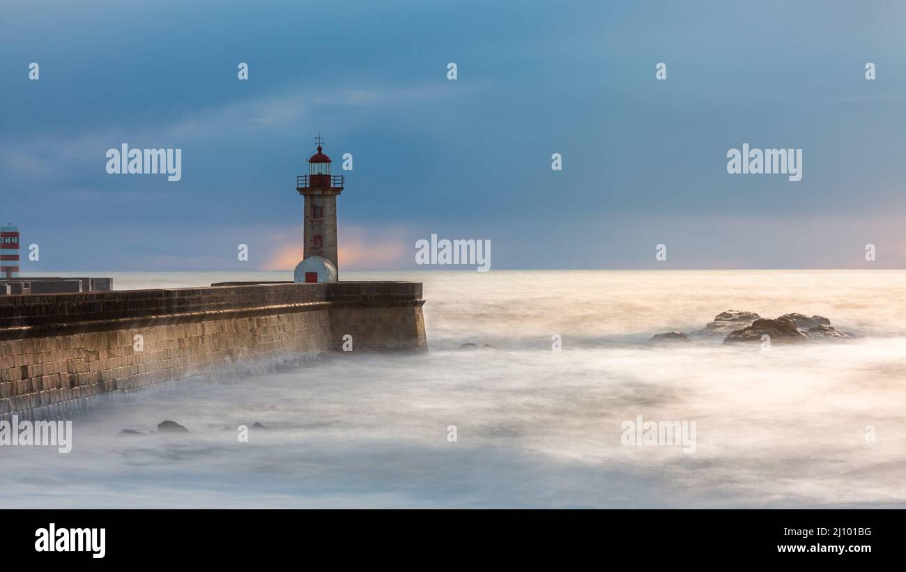 a photo of a lighthouse in the water at a long exposure Stock Photo - Alamy