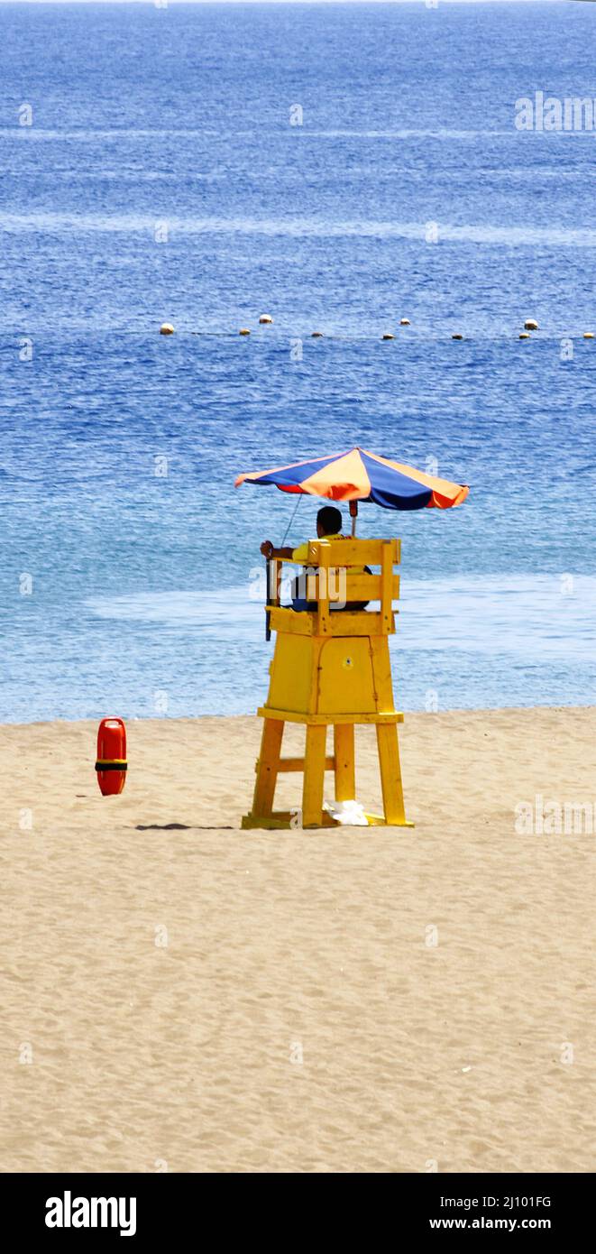 Beach in summer with tourist sunbathing and boat on the horizon Stock ...