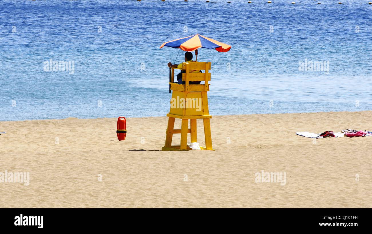 Beach in summer with tourist sunbathing and boat on the horizon Stock ...