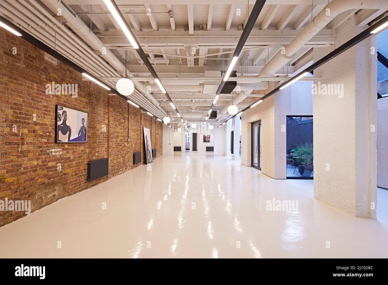 Office space with original brick wall and skylights. Symes Mews, London ...