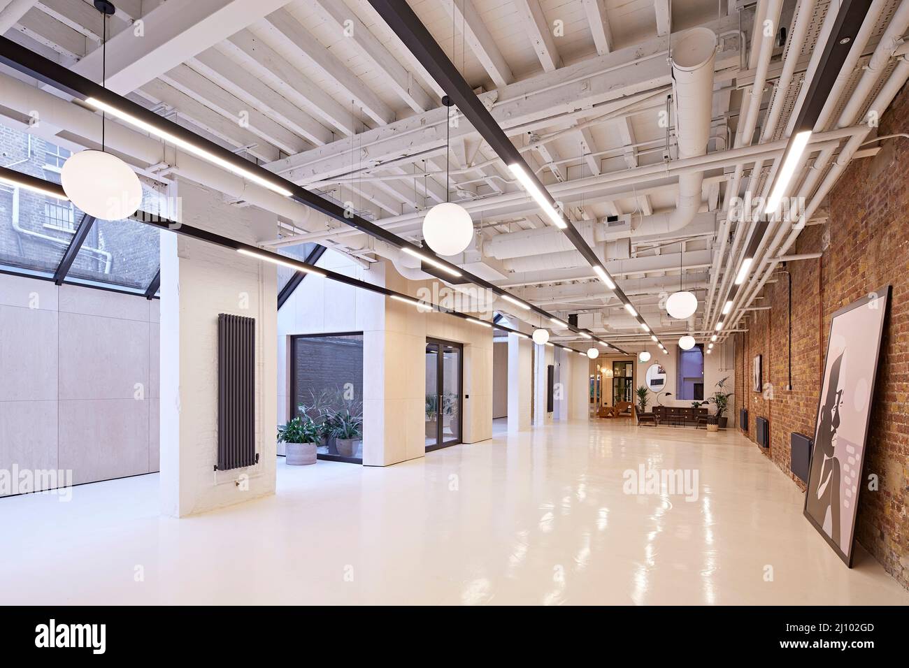 Office space with original brick wall and skylights and large artworks ...
