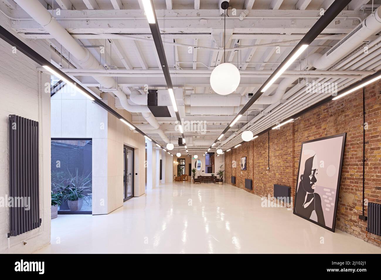 Office space with original brick wall large artworks. Symes Mews ...
