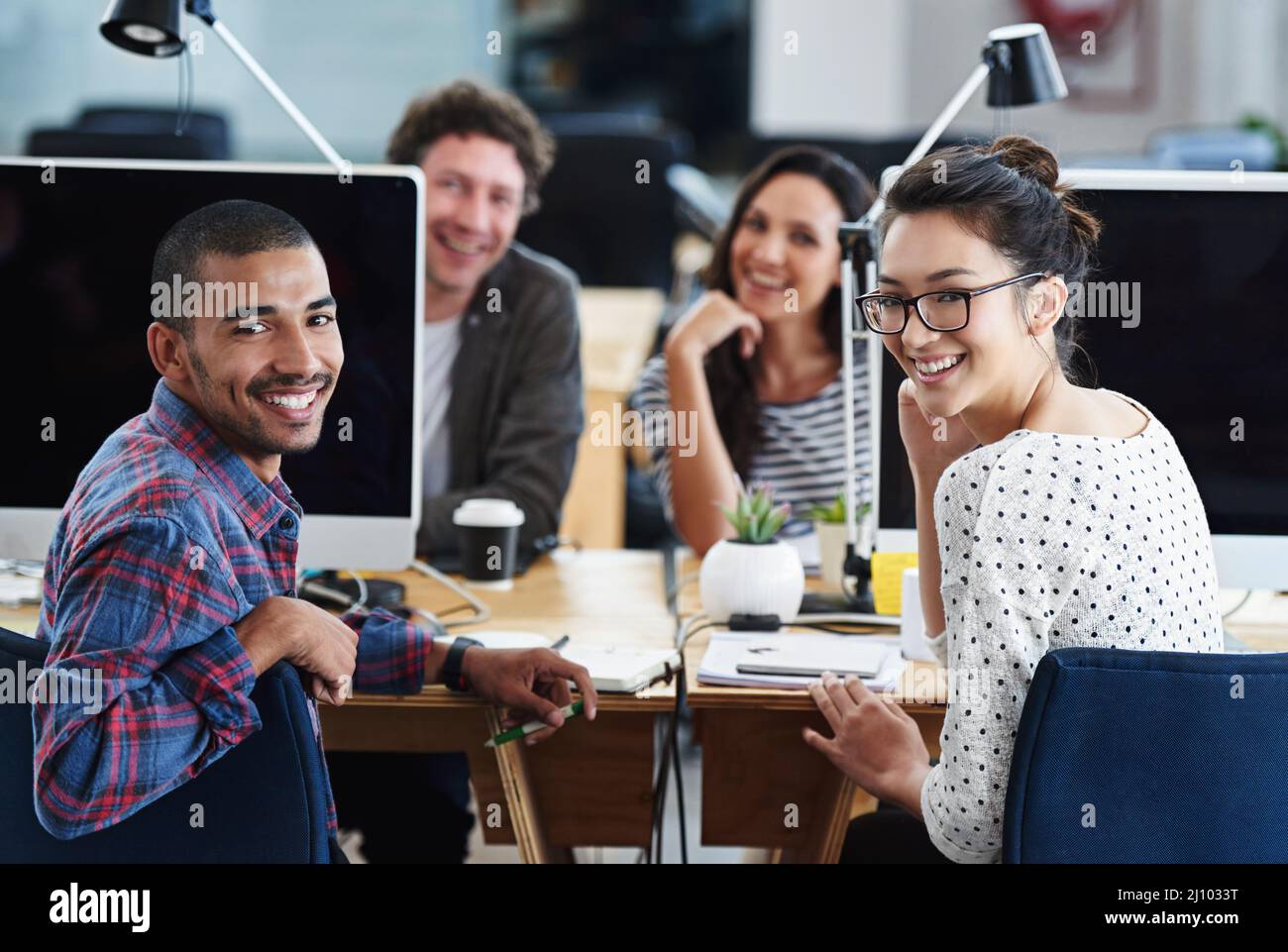 Make creativity a job. Portrait of a group of young office workers ...