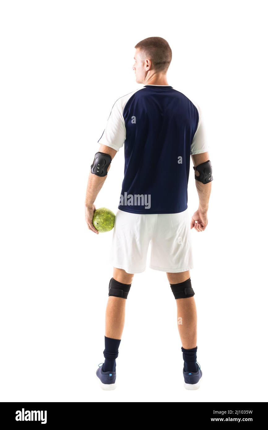 Rear view of young male caucasian handball player holding ball wearing ...