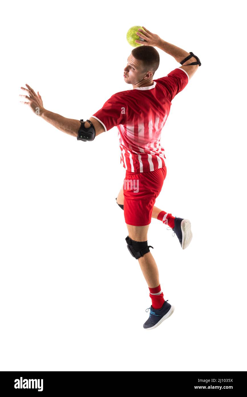 Confident young male caucasian handball player throwing ball against ...