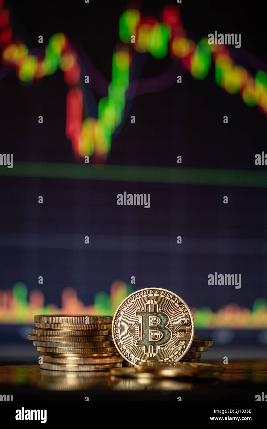 Stack or heap of gold Bitcoins cryptocurrency with candle stick graph ...